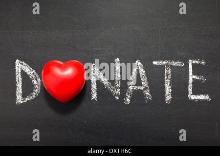 donation word handwritten on school blackboard with heart symbol ...