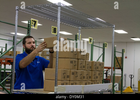 Worker stacking boxes in warehouse Stock Photo: 58216102 - Alamy