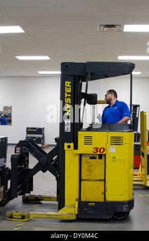 employee working on forklift inside computer technology warehouse Stock ...