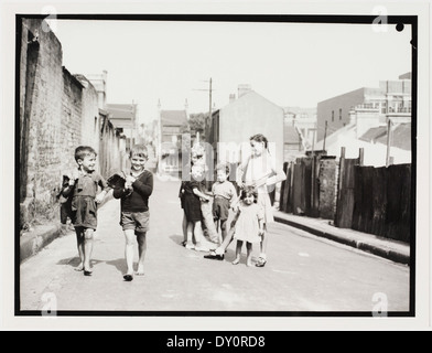This photograph by Ted Hood captures children in the slums of Sydney ...