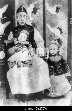 three-year-old Chinese Emperor Puyi (right), standing next to his ...