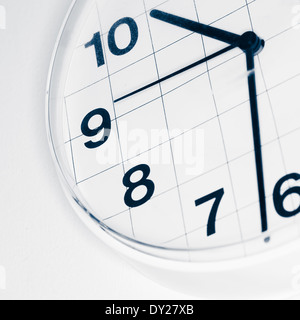 A black and white image of a clock with numbers falling off showing the ...