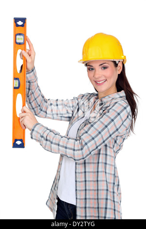 handywoman holding a level ruler Stock Photo - Alamy