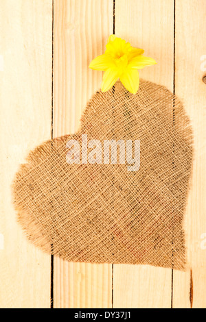 Heart made from linen with daffodil, wooden background Stock Photo - Alamy
