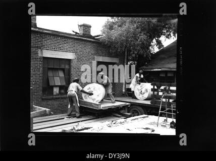 This image shows the loading and unloading of rolls of paper at the H ...