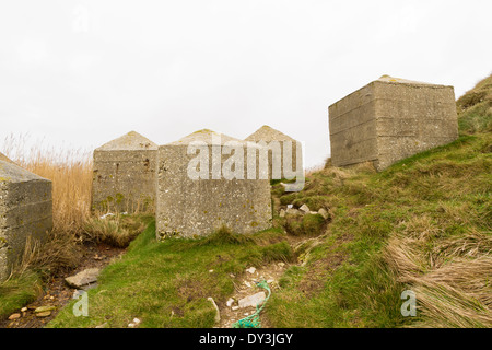 WWII anti tank defense. Blocks of concrete lining the beach head on the ...