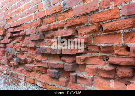 A red brick wall severely weather damaged mainly by frost spalling Stock Photo - Alamy