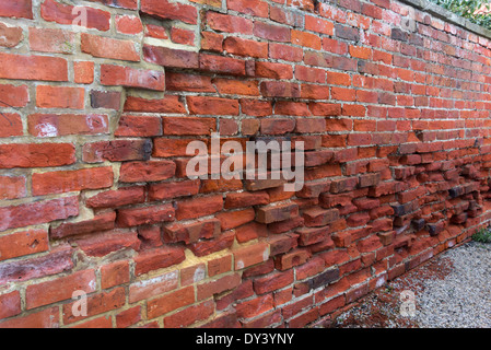 A red brick wall severely weather damaged mainly by frost spalling ...
