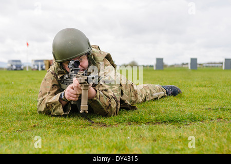 A British Army soldier lies prone on a firing range with a SA80 L85A2 ...