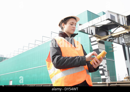 Female dockworker using monitor Stock Photo - Alamy