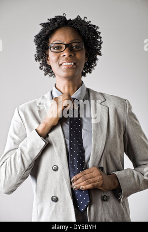 Mature woman putting in contact lenses on brown background Stock Photo ...