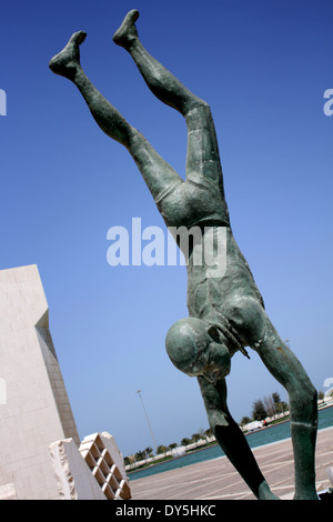 Statue of a pearl diver at the Bahrain National Museum with the Bahrain ...