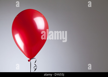 Shiny Red Balloons on a grey background Stock Photo - Alamy