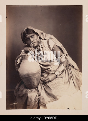 Trinidadian woman in traditional costume carrying a metal milk pail ...