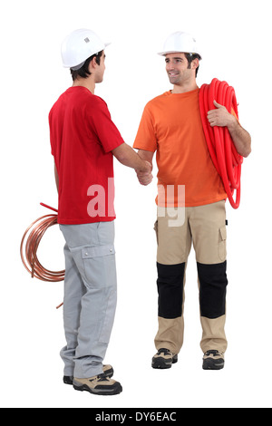 Plumbers shaking hands Stock Photo - Alamy