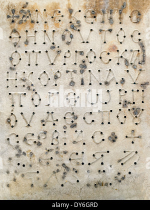 Ancient greek inscriptions on the wall of archeological ruins close-up ...