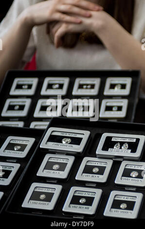 Ramat Gan, Israel. 7th Apr, 2014. A buyer looks carefully at a polished ...
