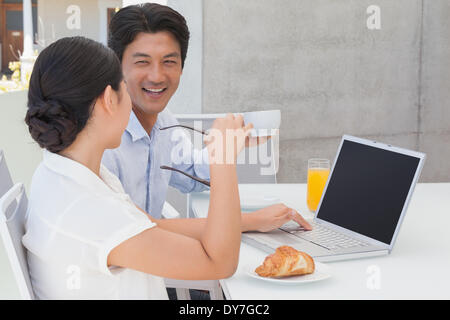 Smiling couple having breakfast together Stock Photo - Alamy