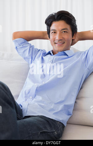 Handsome man relaxing on couch Stock Photo - Alamy