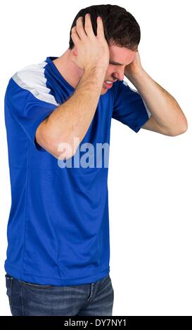 Disappointed football fan in blue jersey Stock Photo - Alamy
