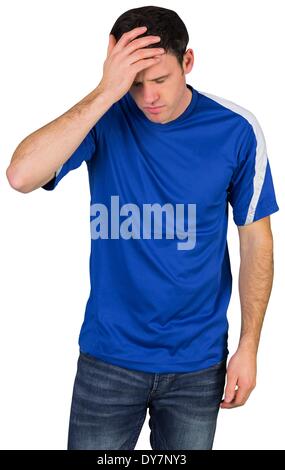 Disappointed football fan in blue on white background Stock Photo - Alamy