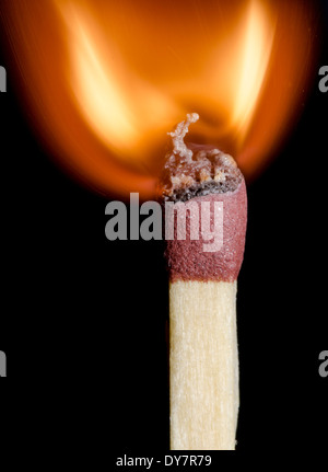 Safety match being struck on side of large matchbox showing match head ...