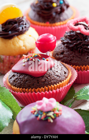 Decorated muffins in muffin papers on cooling grid, elevated view Stock ...