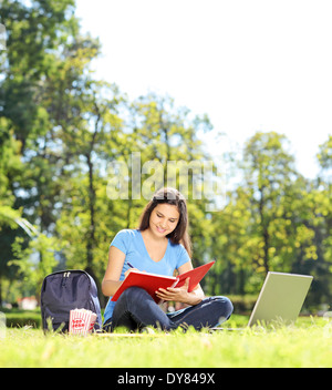 student girl with book writing to notebook at home Stock Photo - Alamy