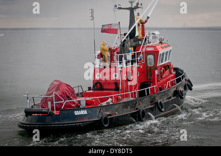 small fireboat demonstrating its capabilities on Baltic Sea in Gdansk ...