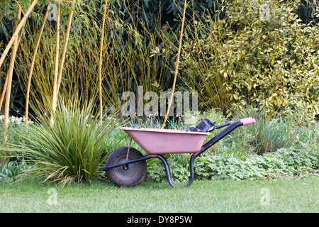Pink Wheelbarrow in a Garden Stock Photo - Alamy