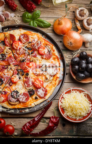pizza top view in rustic setting Stock Photo - Alamy