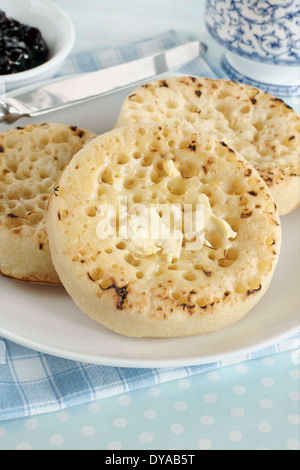 Traditional English Hot Buttered Crumpet with melting butter Stock ...