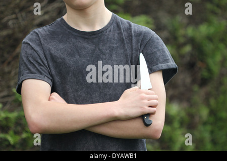 Knife crime boys hand holding a kitchen knife A meat cleaver Stock ...