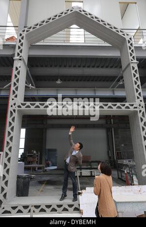 The inventor of 3D-printed house Ma Yihe (L) shows the 3D-printed ...