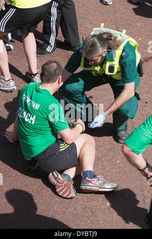 A runner collapses at the finish line of the Virgin money London ...