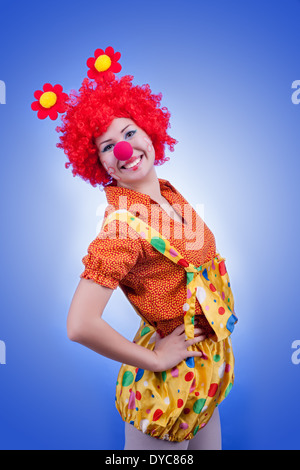 woman with clown makeup and colored hair showing hush sign while ...