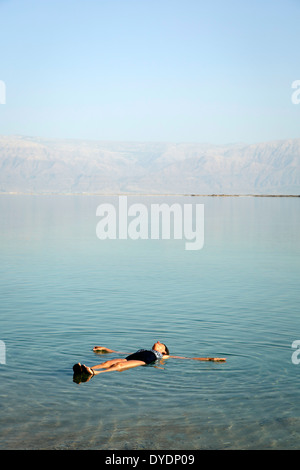 Israel, Dead Sea People float in the heavy water of the Dead Sea Stock ...