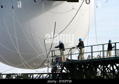 Raytheon flight crew employees launch a tethered unmanned aerostat part of the US Army Joint ...