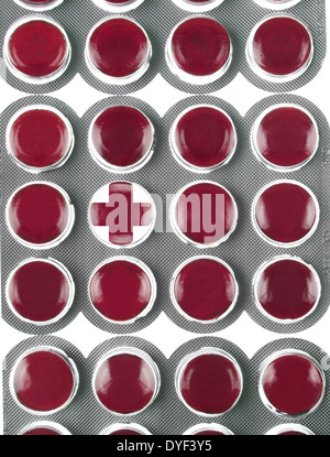 PACKETS OF PURPLE THROAT LOZENGES WITH ONE AS A CROSS Stock Photo - Alamy