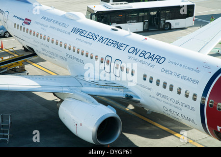 Wifi internet access in airplane during flight, passenger using tablet ...