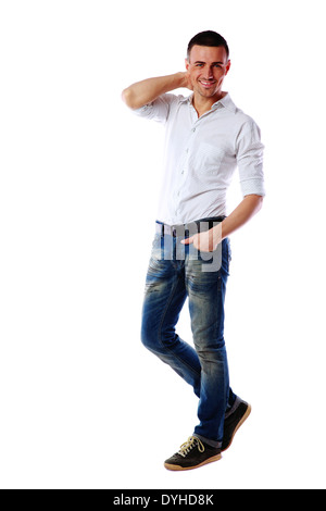 Full body portrait of fashionable happy man on telephone call by ...