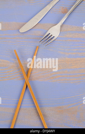 Chopsticks vs knife and fork, a concept Stock Photo - Alamy