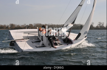 A disabled sailor receives instruction in a dual purpose sailing dinghy ...