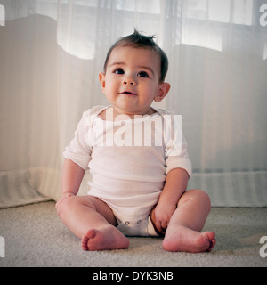 Baby boy sitting in the room Stock Photo - Alamy