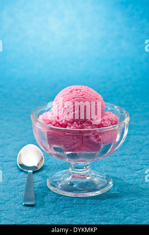 raspberry ice cream over a blue background Stock Photo - Alamy