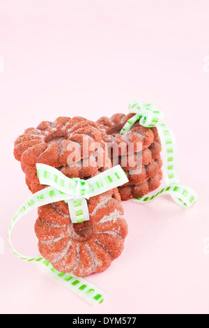 Stack of chocolate cookies against pink background Stock Photo - Alamy