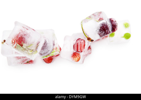 Frozen ice cubes with various fruits, blackberries and raspberries ...