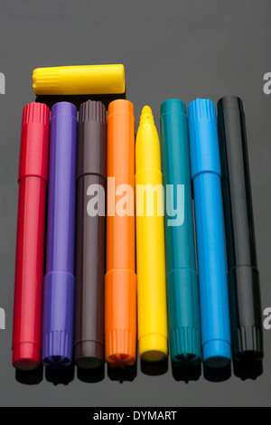 A set of colorful felt-tip pens on a cup on a yellow table Stock Photo ...
