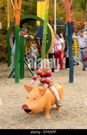 Kid ride pig model at a playground Stock Photo - Alamy