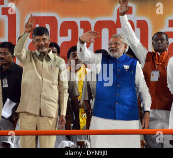 Telugu Desam Party (TDP) President N. Chandrababu Naidu, left, displays the victory symbol to ...